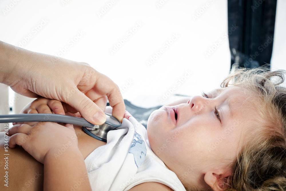 Pediatric doctor listening to a crying baby with a stethoscope Stock ...