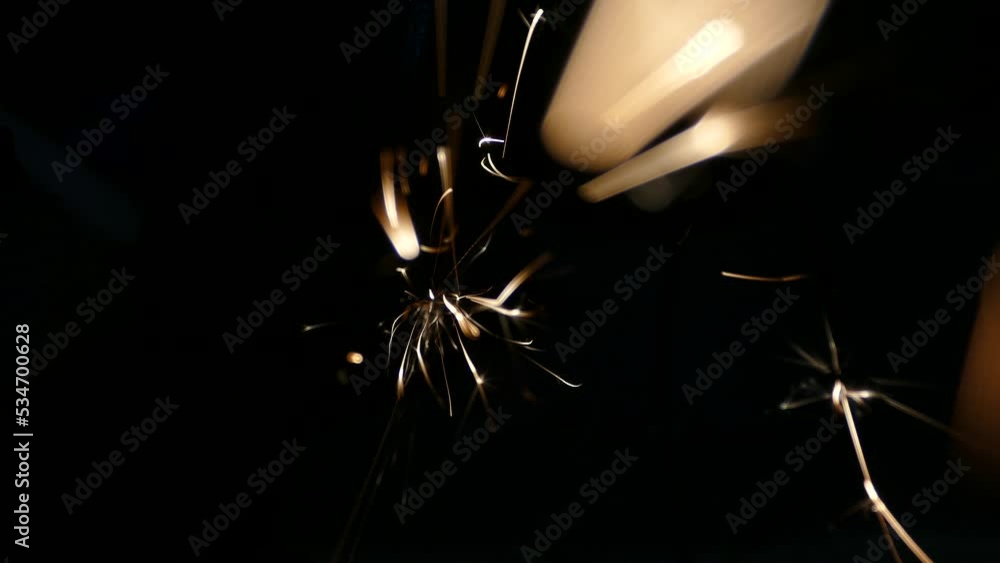 Bright sparks on a black background. Sparks of fire fly and fall. Cut ...