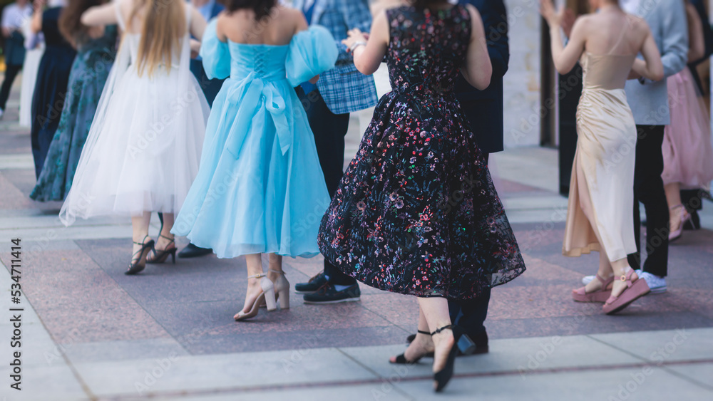 High school graduates dancing waltz and classical ball dance in dresses ...