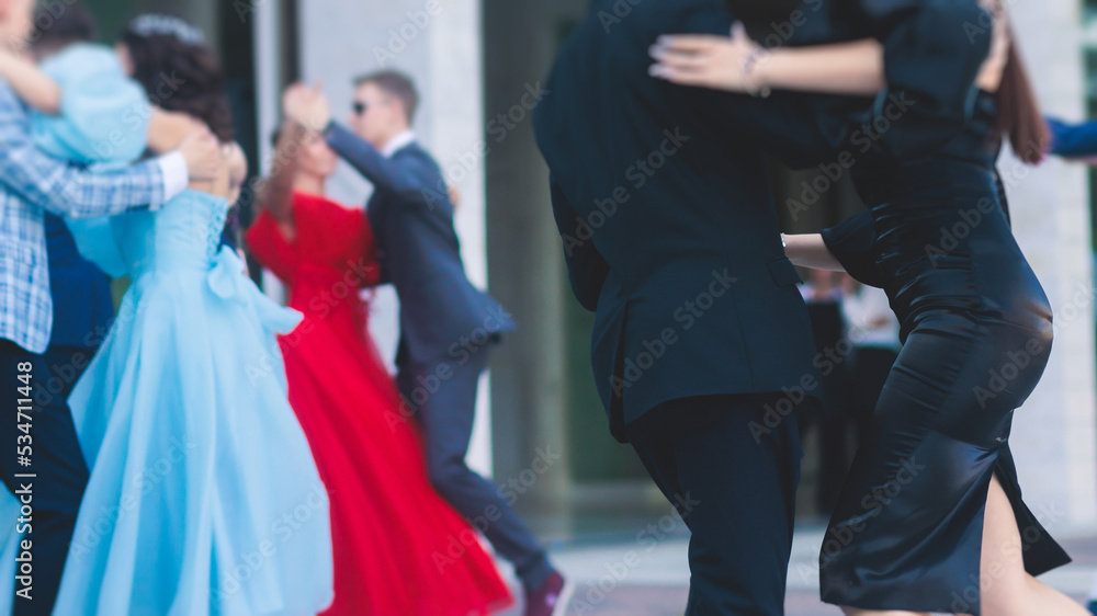 High school graduates dancing waltz and classical ball dance in dresses ...