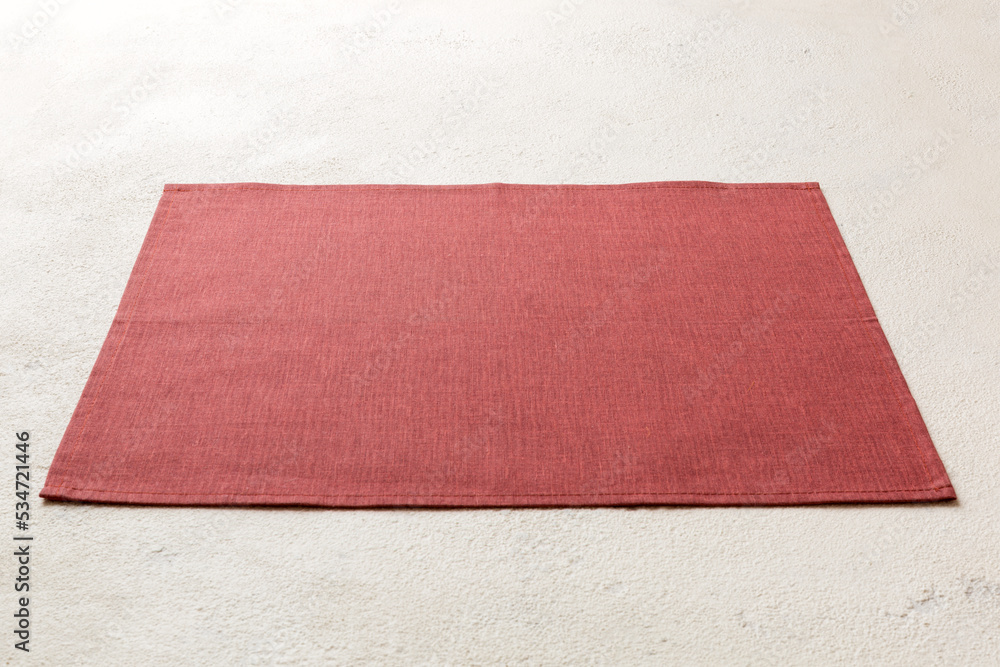 Perspective view of red tablecloth for food on cement background. Empty ...