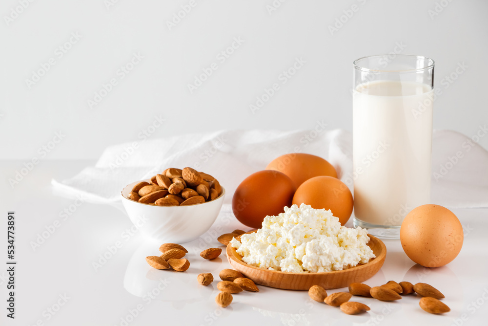 Protein food on a white background - cottage cheese, eggs, nuts. A set ...