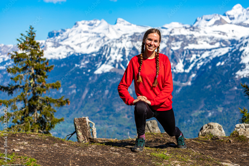 Foto de sweet woman with pigtails stretches and does yoga on top of a ...