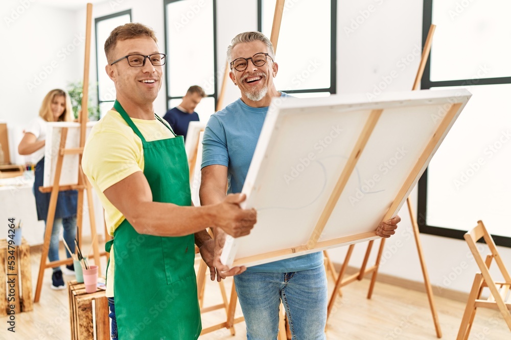 Group of middle age people drawing at art studio. Two students smiling ...