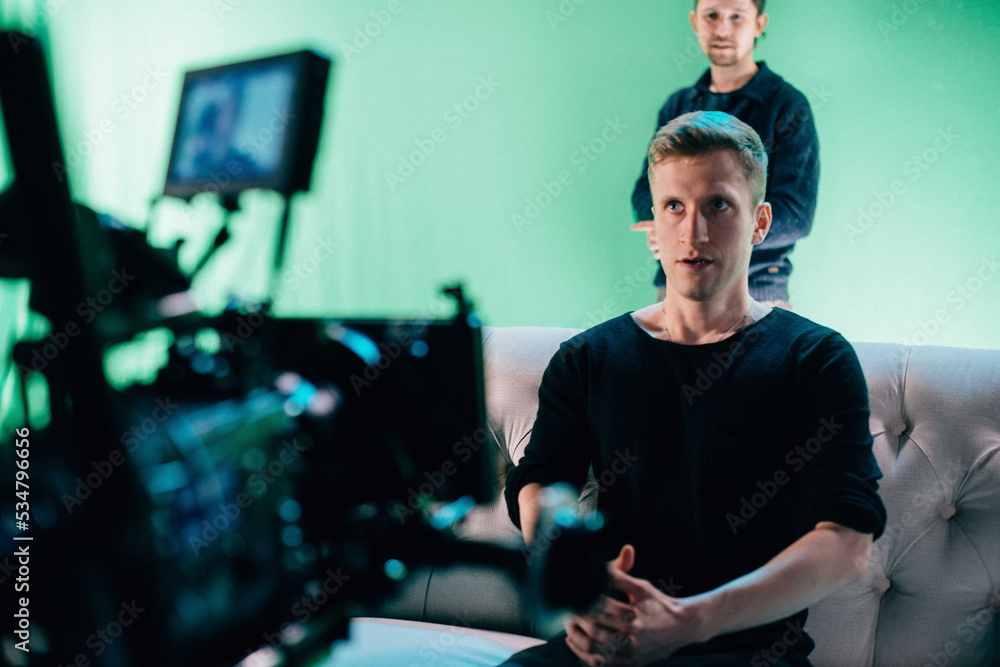 Professional male actors work in the frame on the set. Shooting with ...