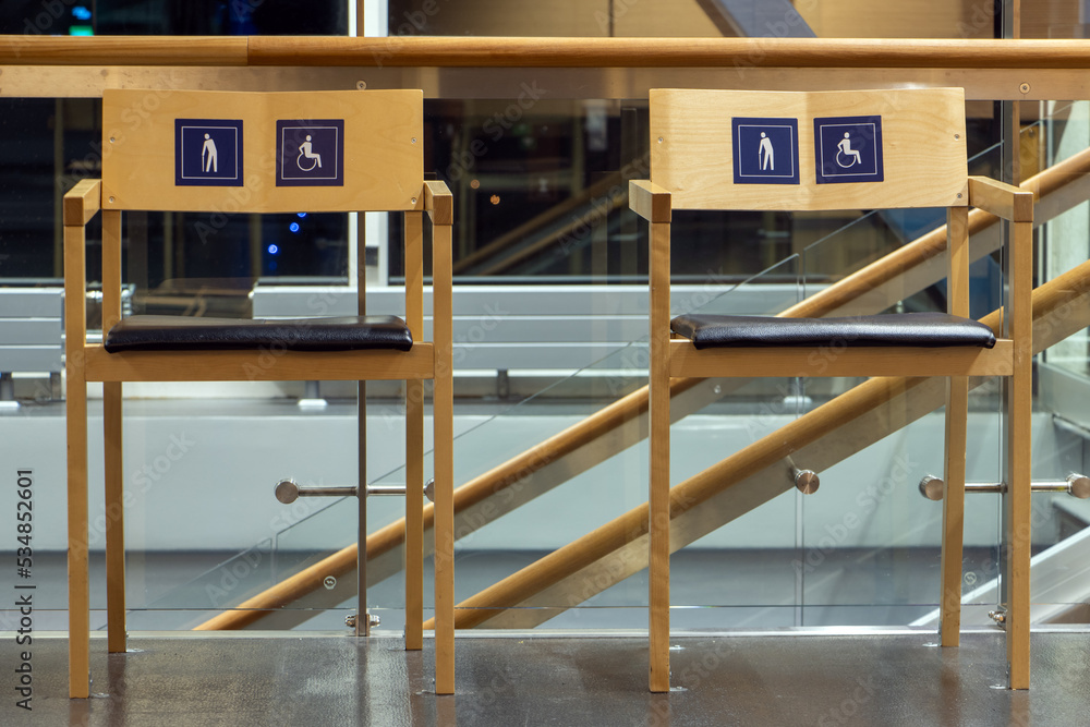 Chairs marked with disabled and senior logos in the corridor Stock ...