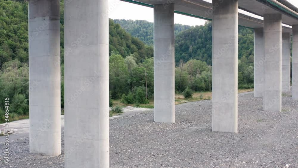 Reinforced concrete pillars supporting a bridge on a highway. Columns ...