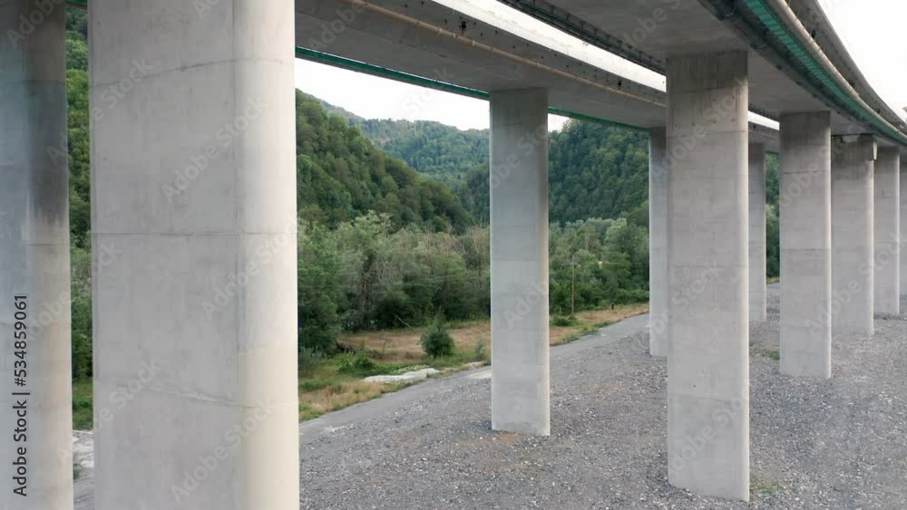 Reinforced concrete pillars supporting a bridge on a highway. Columns ...