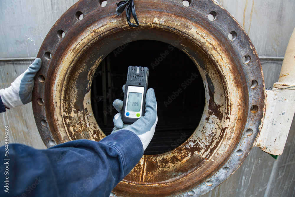Worker hand holding gas detector inspection safety gas testing at front ...