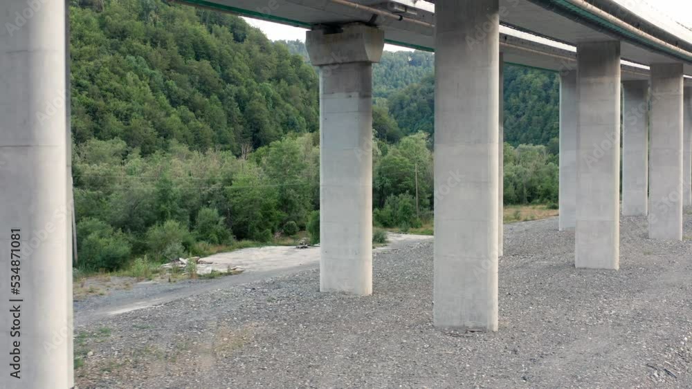 Reinforced concrete pillars supporting a bridge on a highway. Columns ...