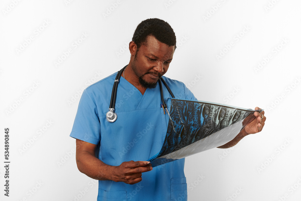 Black surgeon doctor bearded man in blue coat with stethoscope holds X ...