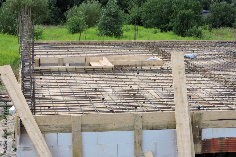 A steel reinforcement for the concrete floor and pillars on the first ...
