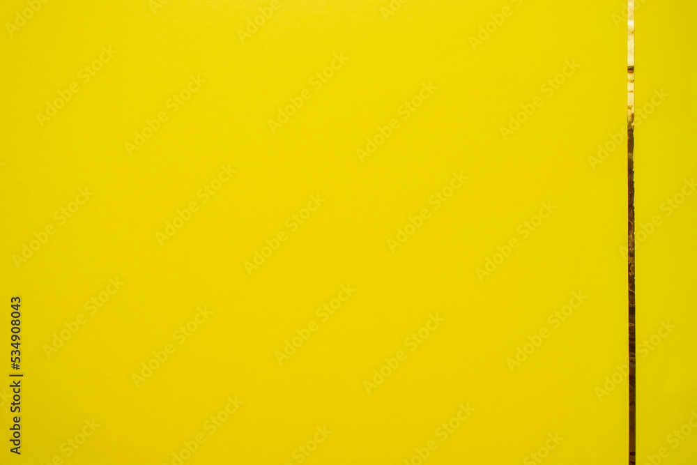 Yellow sun color background with paper texture and golden ribbon ...