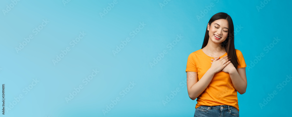 Lovely asian woman with dark haircut close eyes press hands heart ...
