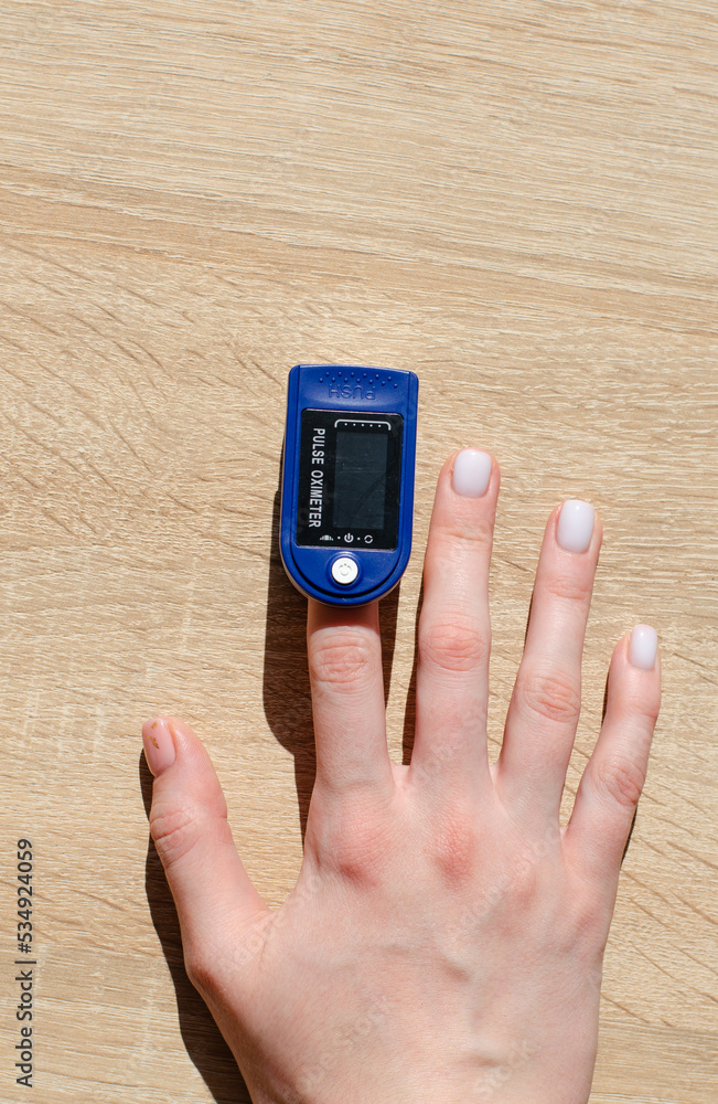Pulse oximeter. Medical device on the finger. Patient diagnosis. Covid ...