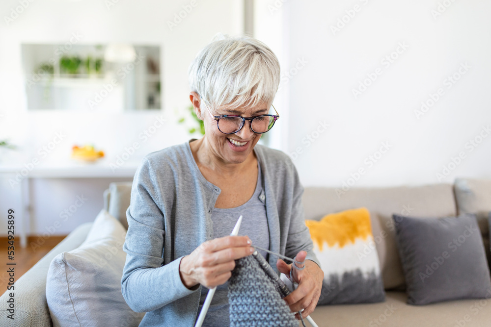 Grandmother holding needles make repetitive motion knitting sitting on ...