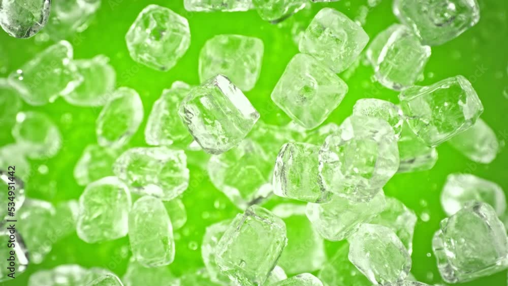 Super Slow Motion Shot of Ice Cubes Explosion Towards Camera on Green ...