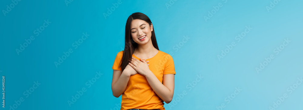 Lovely asian woman with dark haircut close eyes press hands heart ...