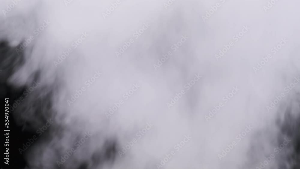 White smoke on black background. A cloud of vapor steam rises up ...