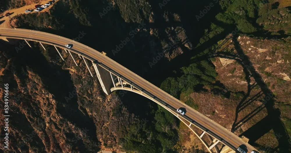 Descending above the gap between the mountains connected by the arched ...