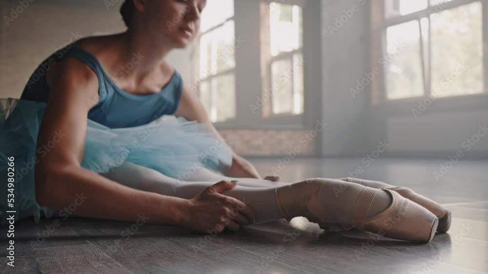 Flexible ballerina stretches back and legs sitting on floor Stock Video ...