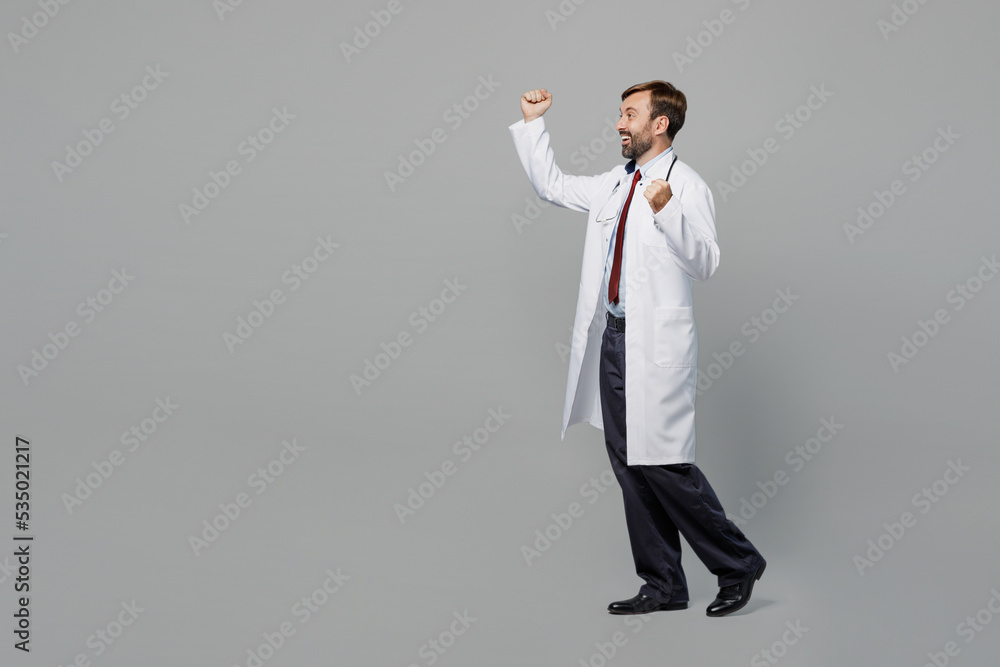 Side view full body happy fun male doctor man wears white medical gown ...