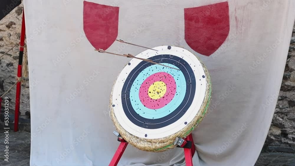 Medieval straw target with flying arrows and missing the target against ...