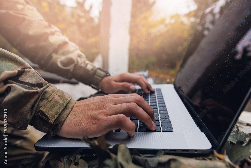 Soldier engineer use laptop for transmits aerial photo and data from ...