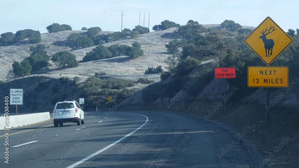 Deer crossing warning yellow sign, California USA. Wild animals xing ...