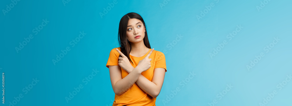 Confused cute asian female student thinking what do, look sideways ...