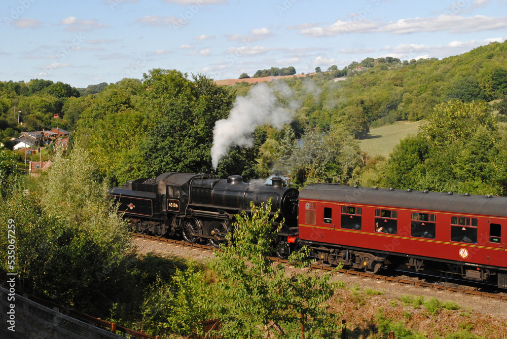 Steam Locomotive and Train Approaching on Rural Heritage Railway Stock ...