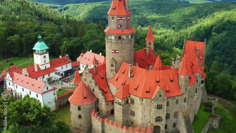 Pointed terracotta roof of ancient knight Bouzov castle surrounded by ...