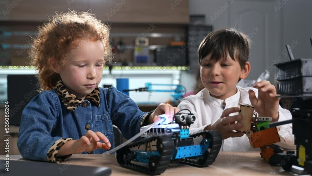 Enthusiastic elementary school children playing and constructing ...