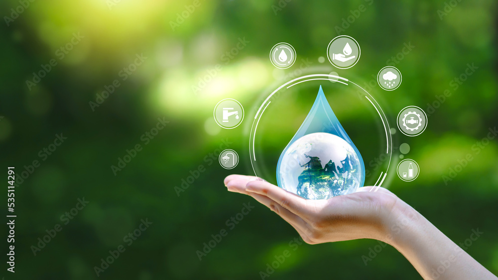 Water drop in hand against natural background in Save water concept on ...
