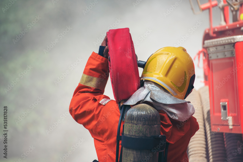 Firefighter Rescue training in fire fighting extinguisher. Firefighter ...