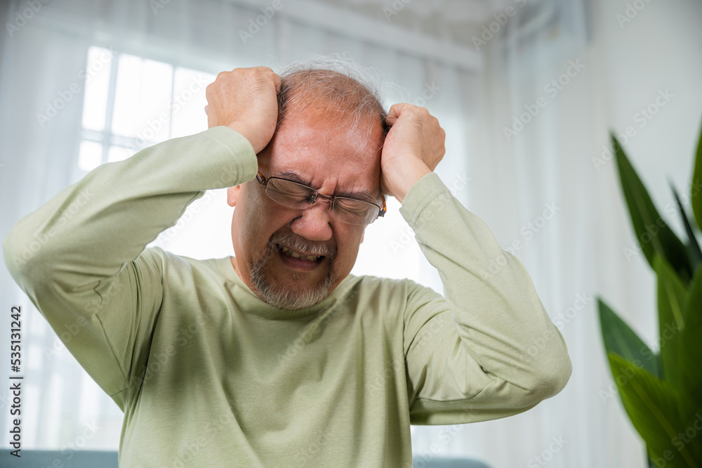 Headache. Close up of elderly holds head with hand suffering from ...
