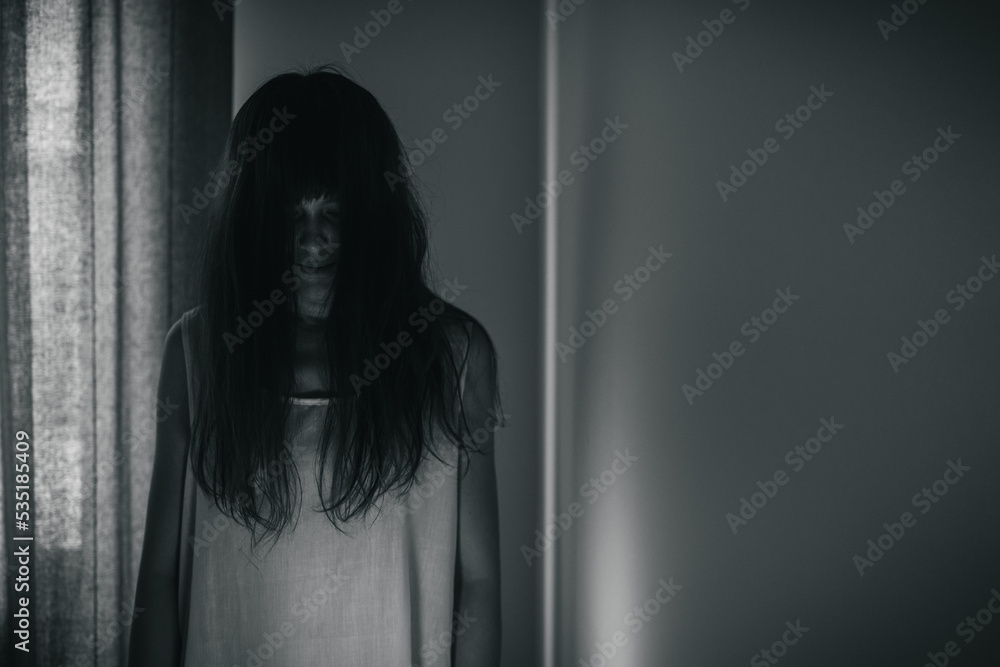 Female ghost in white dress in room. A young scary girl in an old white ...