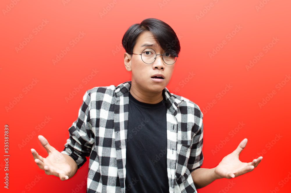 young asian man looks puzzled, confused, stressed and wondered with ...