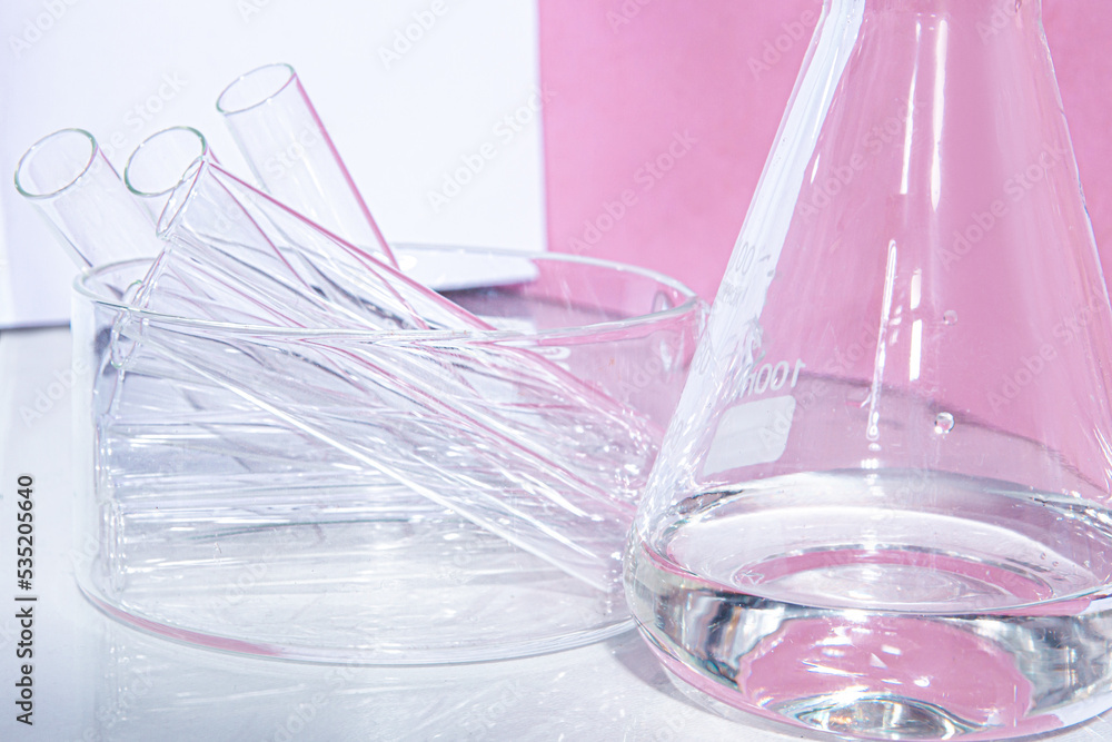 Transparent glass flask on a pink background. science research ...