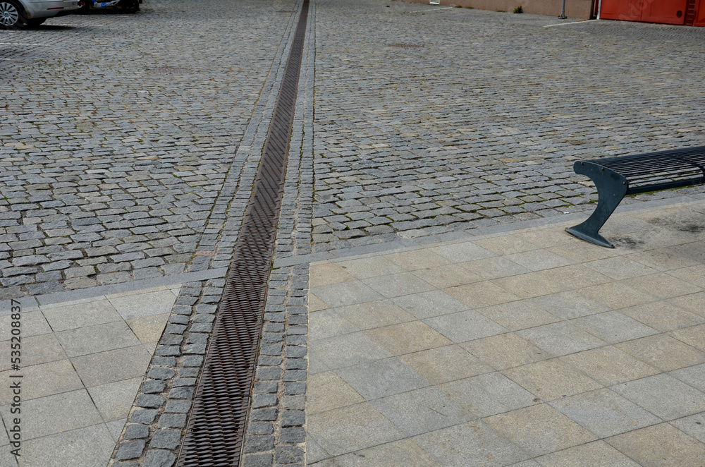 across the path there is a channel with a metal grid for drainage ...