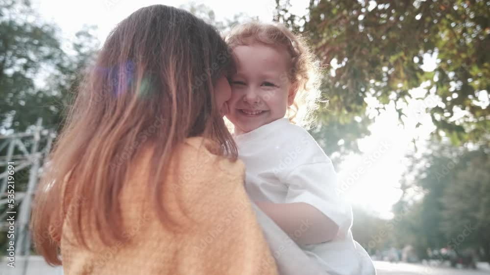 Loving Mother Walks With Her Cute Daughter In The Park Mom Holds Her