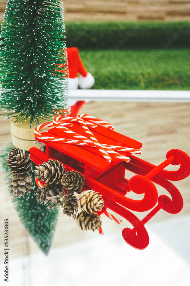 Classic christmas background with a red sled and a christmas tree over ...