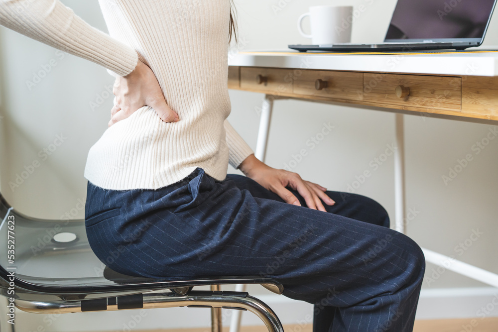 office syndrome, woman with back pain symptoms during work in the ...