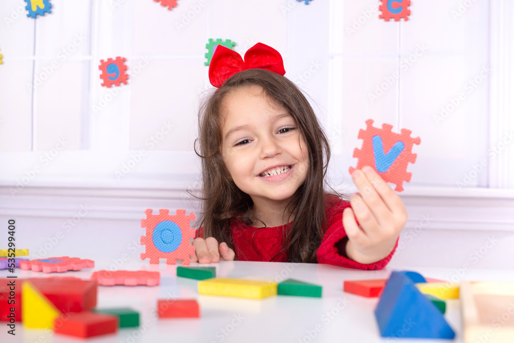 Child learns letters and numbers through play.Portrait of a 4-year-old ...