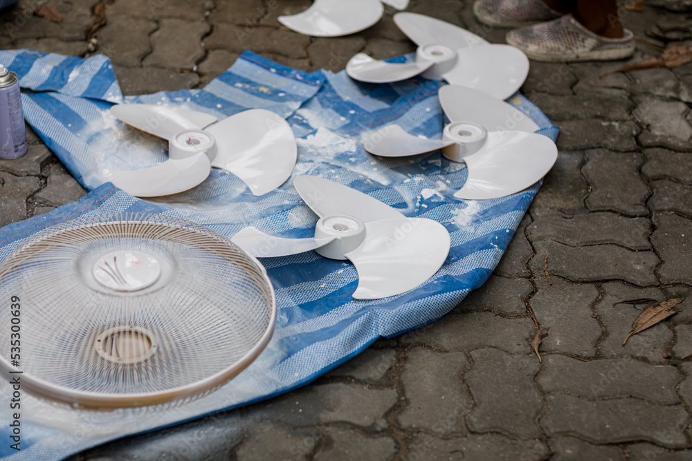 The old fan blade has been sprayed with new paint to make it look ...