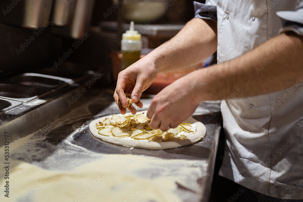 Pizza making process. Male chef hands making authentic pizza in the ...