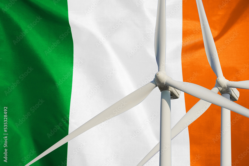Two Wind Turbines for alternative energy on Ireland flag background ...