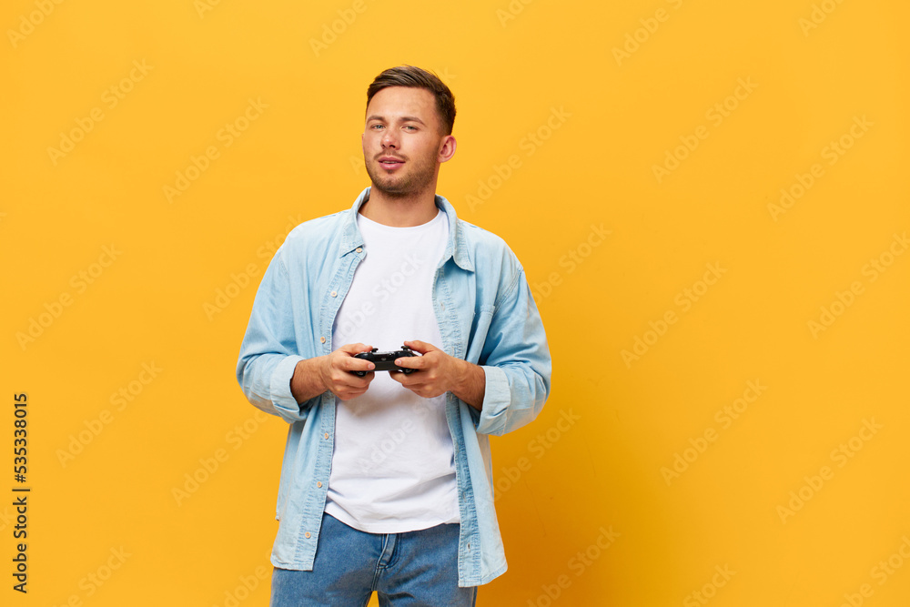 Serious concentrated tanned handsome man in blue basic t-shirt play new ...