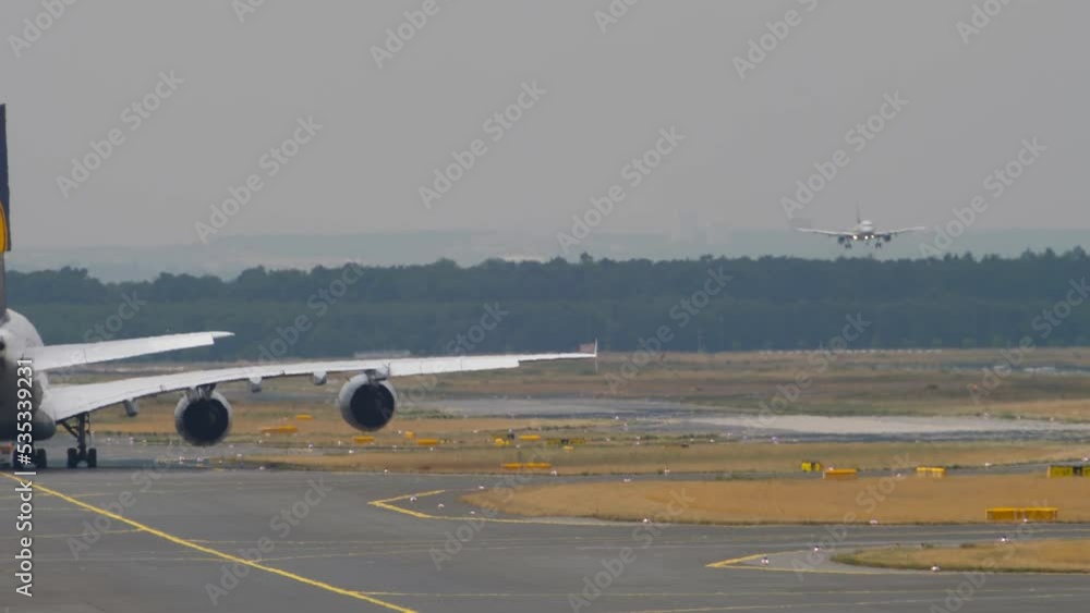 Rear view of a huge wide-body airliner on the taxiway. Long shot ...