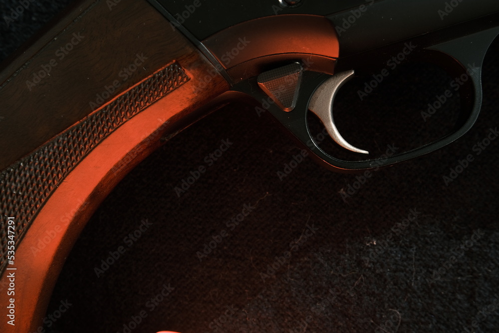 Trigger of a rifle on black background with red lightning Stock Photo ...
